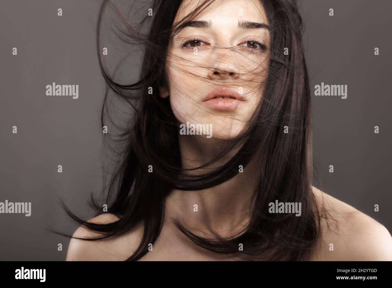 beauty fashion studio portrait of a beautiful young girl with windy ...