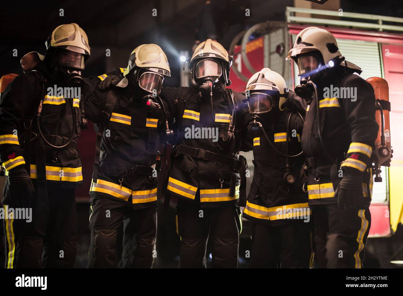 Group of professional firefighters posing. Firemen wearing uniforms ...