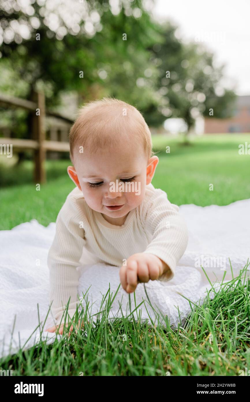 Baby boy discovering grass Stock Photo - Alamy