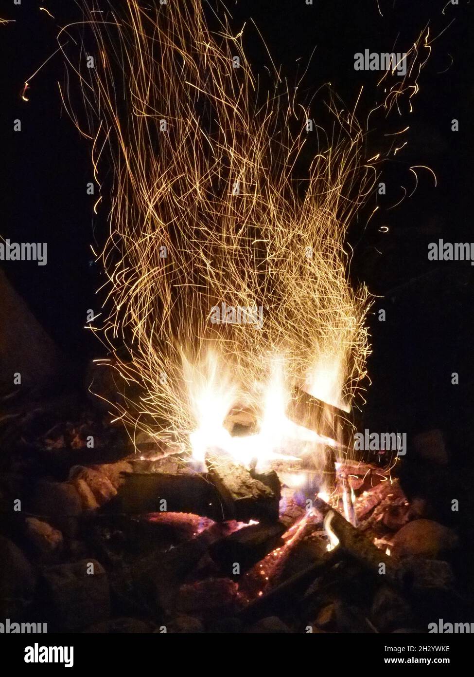 The sparkling lights from burning firewood outdoors Stock Photo - Alamy