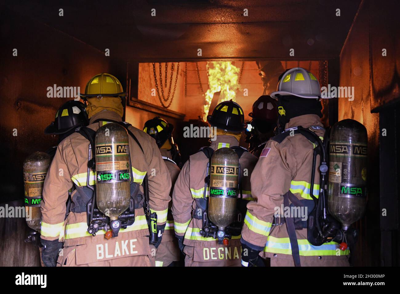 A group of 319th Civil Engineering Squadron firefighters stand in a ...