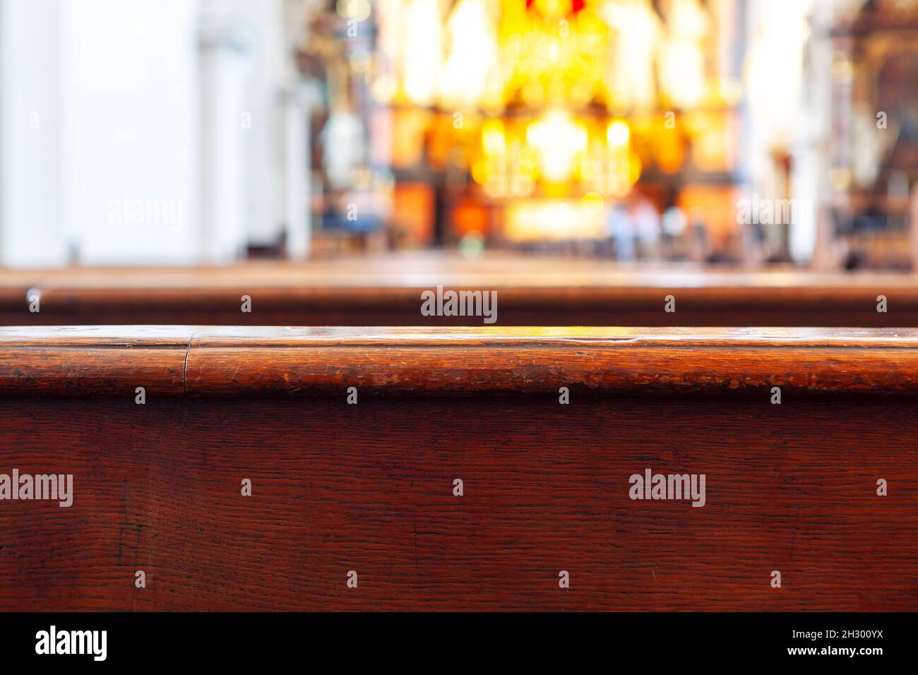 Wooden praying bench with blurry background . Inside of the church ...