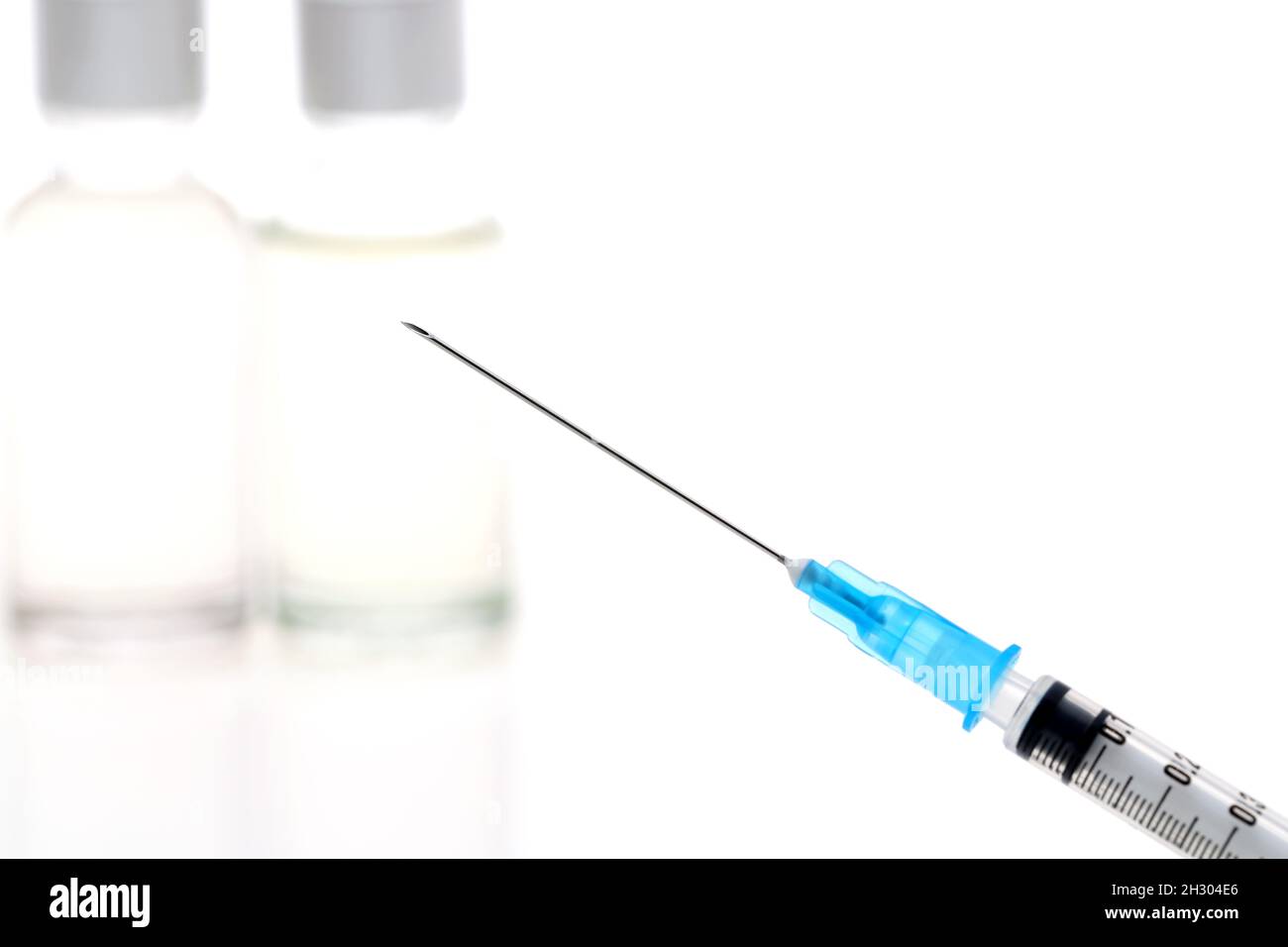 medical disposable syringe with vaccine bottle on white background ...