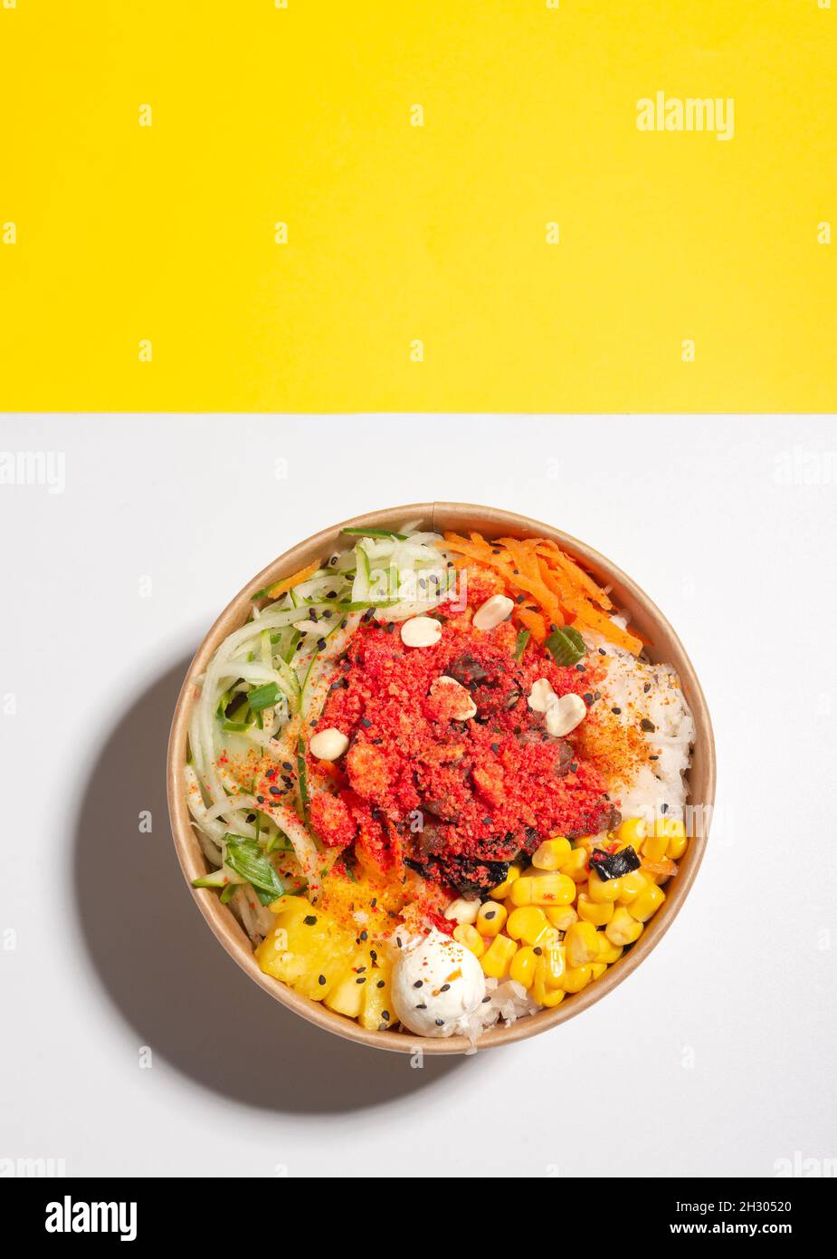 a salad poke with yellow bottom, asian hawaiian food, chopsticks ...