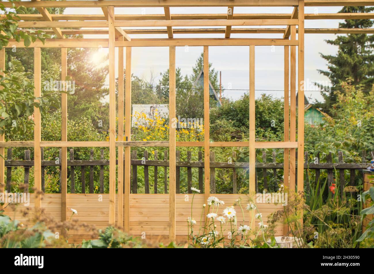 Wooden frame construction of a new veranda or gazebo on the territory ...