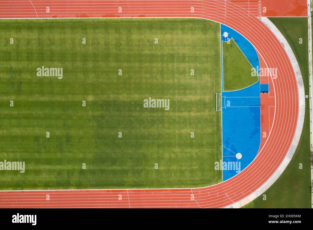 Aerial view of empty new soccer field from above with running tracks ...