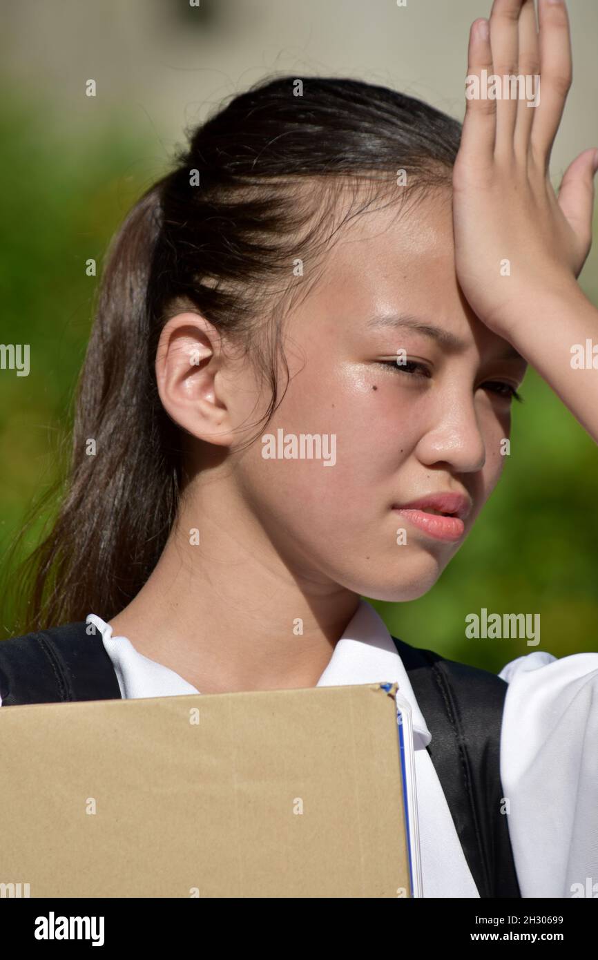 Female Student And Memory Loss With School Books Stock Photo - Alamy