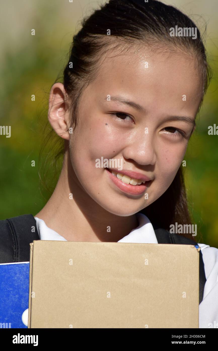 Youthful Filipina Female Student Smiling With Books Stock Photo - Alamy