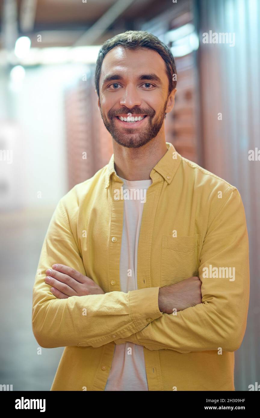 Smiling man standing in lighted room Stock Photo - Alamy