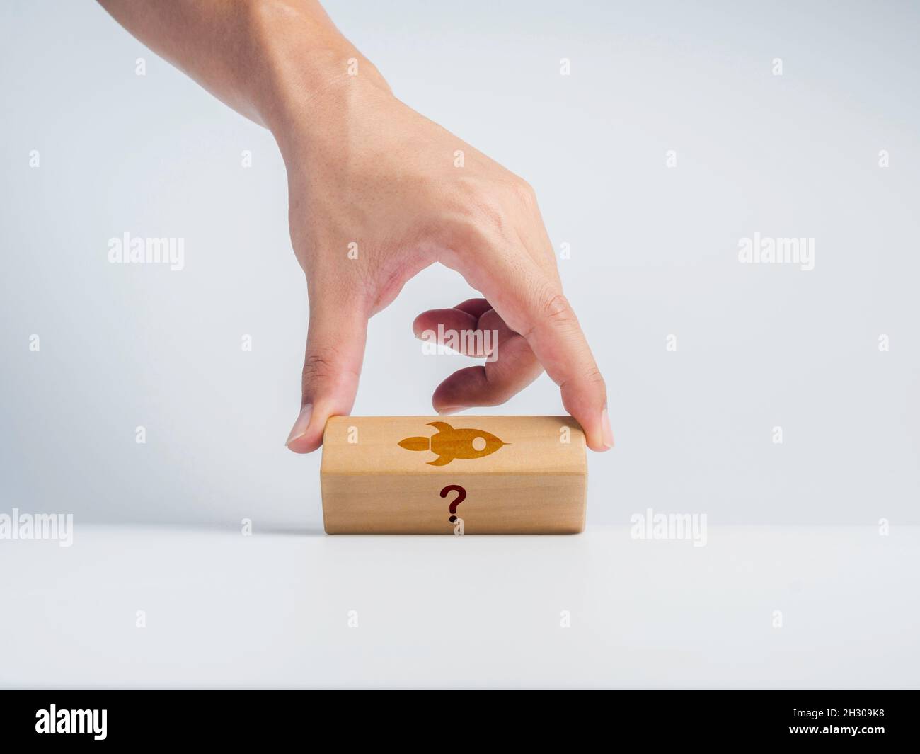 Business startup concept. The man's hand flipping wooden block with ...