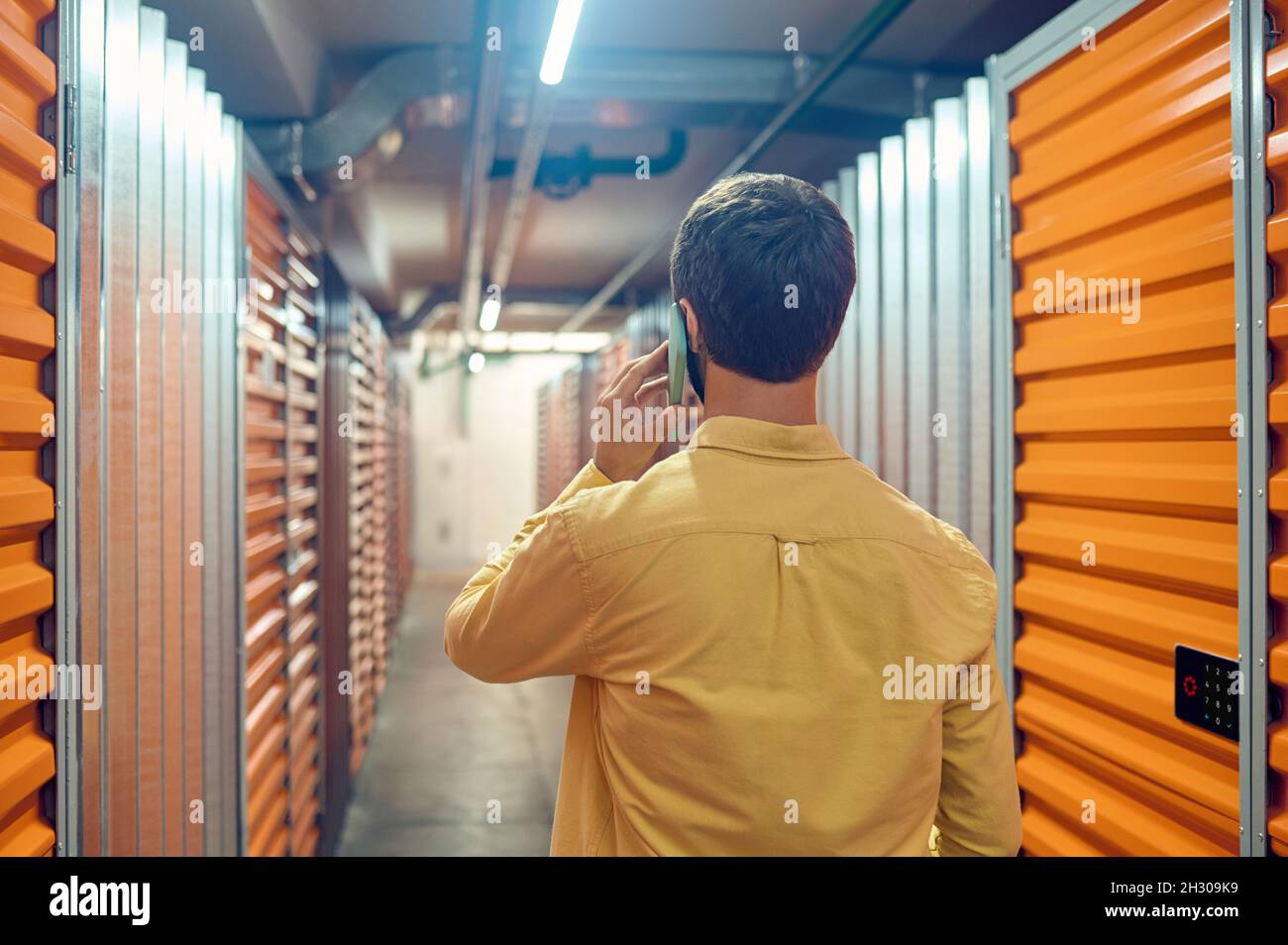 Back view of man talking on smartphone Stock Photo - Alamy