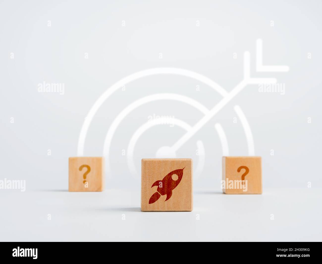 Business startup concept. Wooden cube block with rocket symbol in front ...