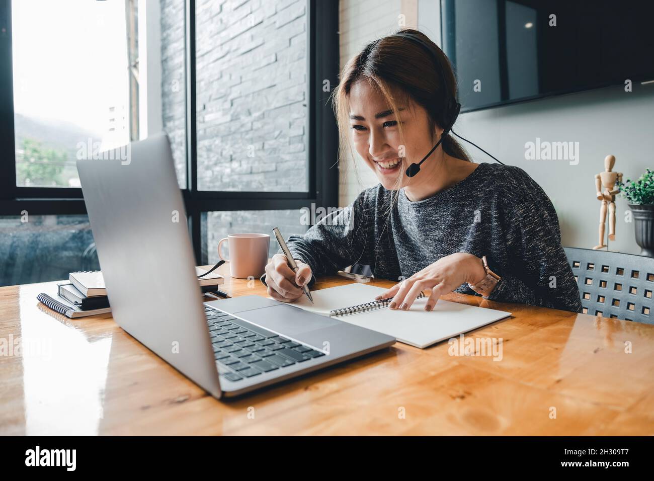 Happy asian woman student watching lesson online and studying from home ...