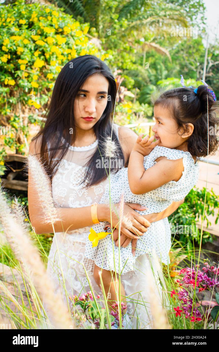 Mother embracing her daughter. Outdoor Portrait in the park, around the river Stock Photo - Alamy