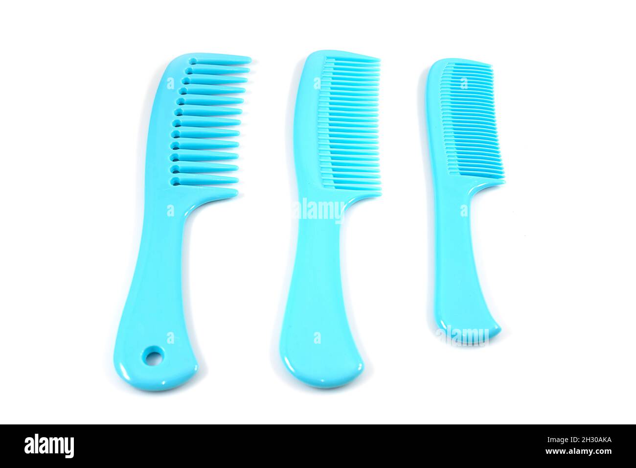 Set of blue plastic comb isolated on white background Stock Photo - Alamy