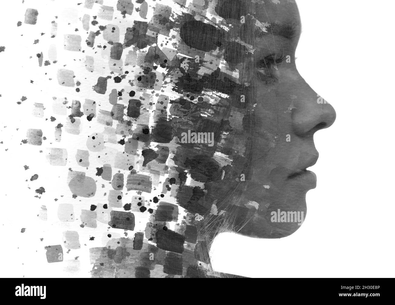 A black and white profile portrait of a young woman dissolving into ...