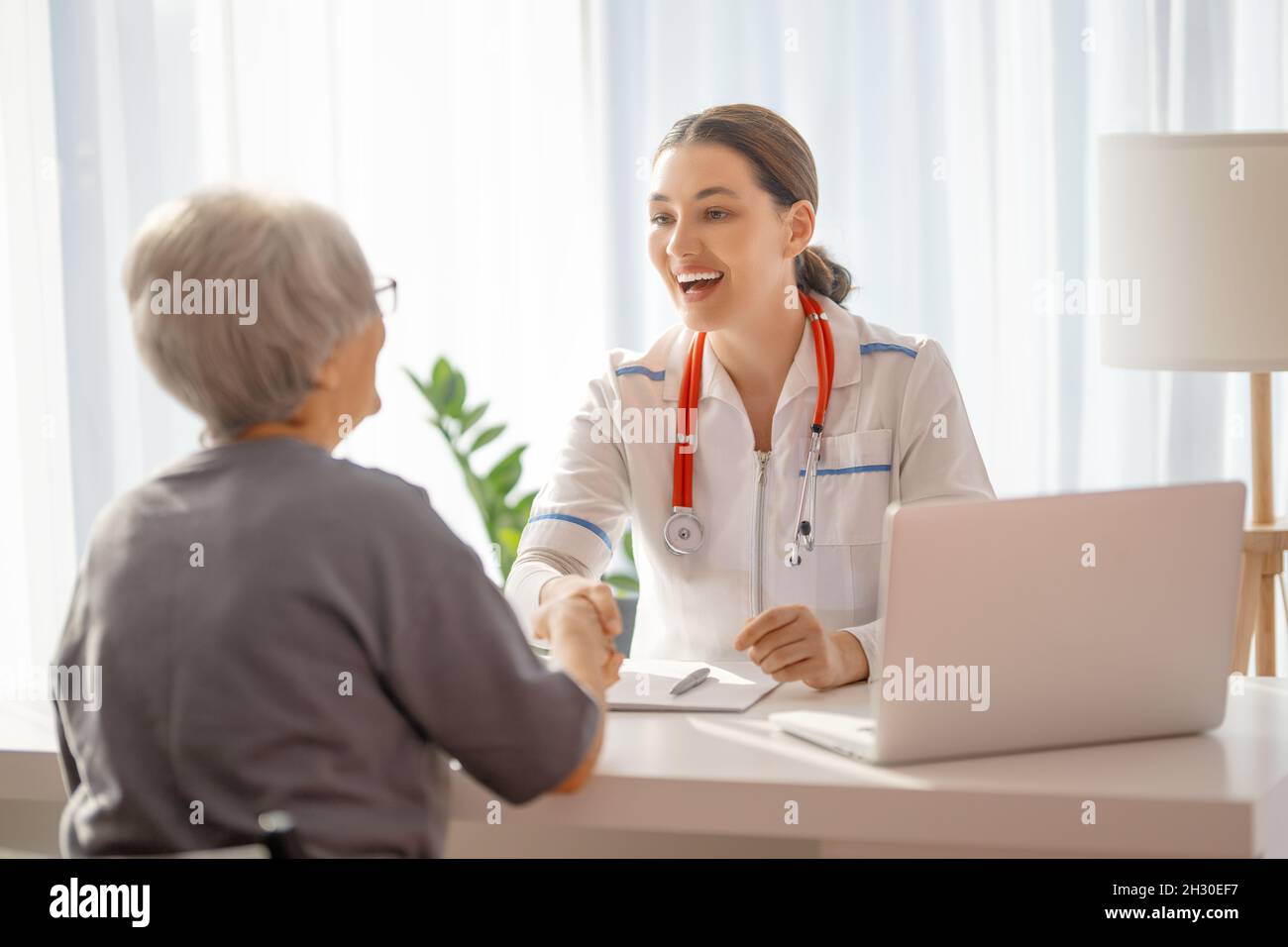 Female patient listening to a doctor in hospital Stock Photo - Alamy