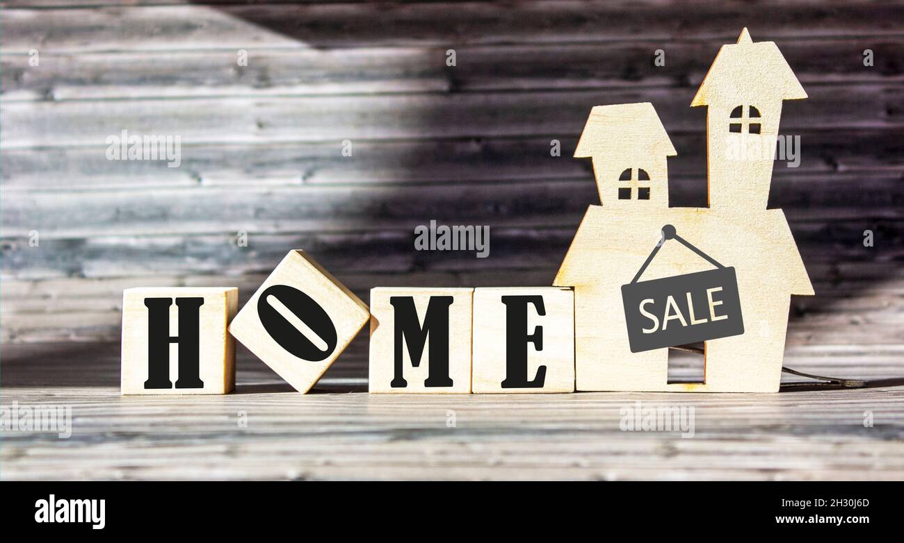 The text house is written on wooden blocks and a dark table. Home ...