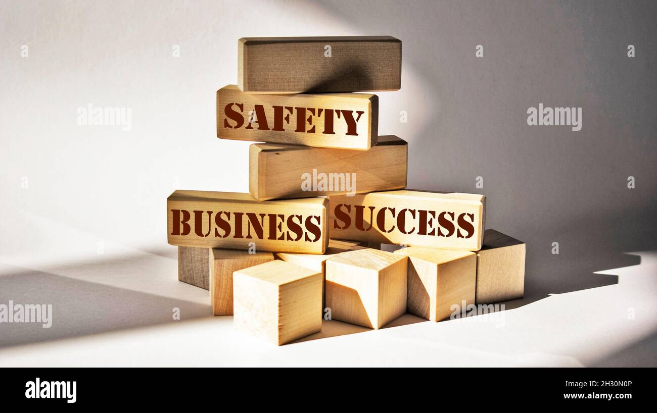 Text success, business, security written on wooden blocks and white ...