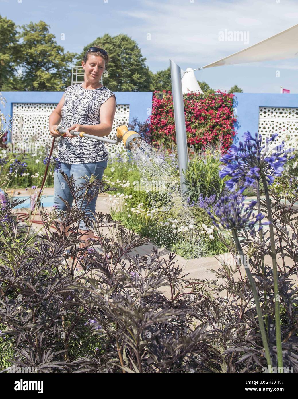 A gardener waters the Noble Caledonia 'Spirit of the Aegean' garden as ...
