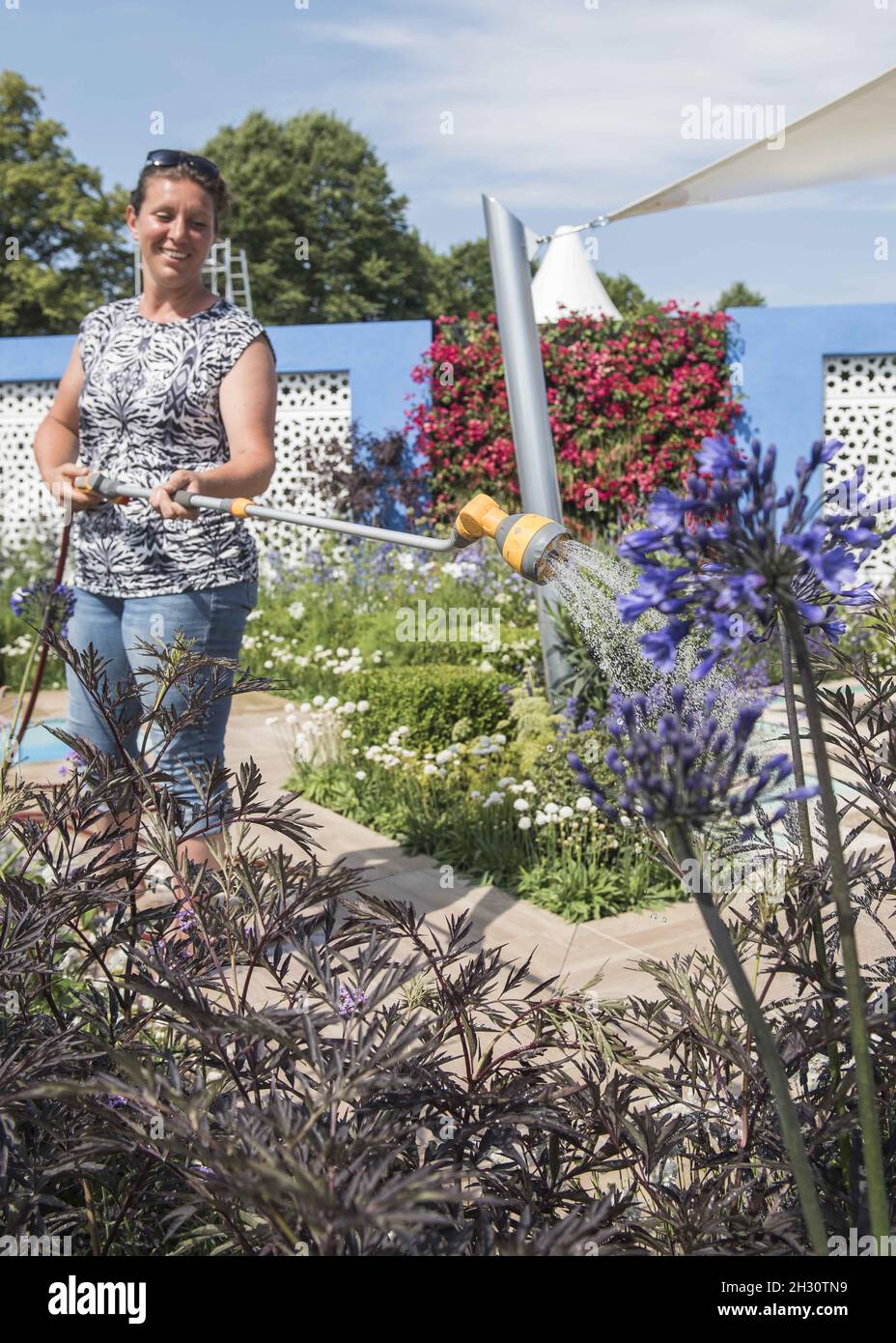 A gardener waters the Noble Caledonia 'Spirit of the Aegean' garden as ...