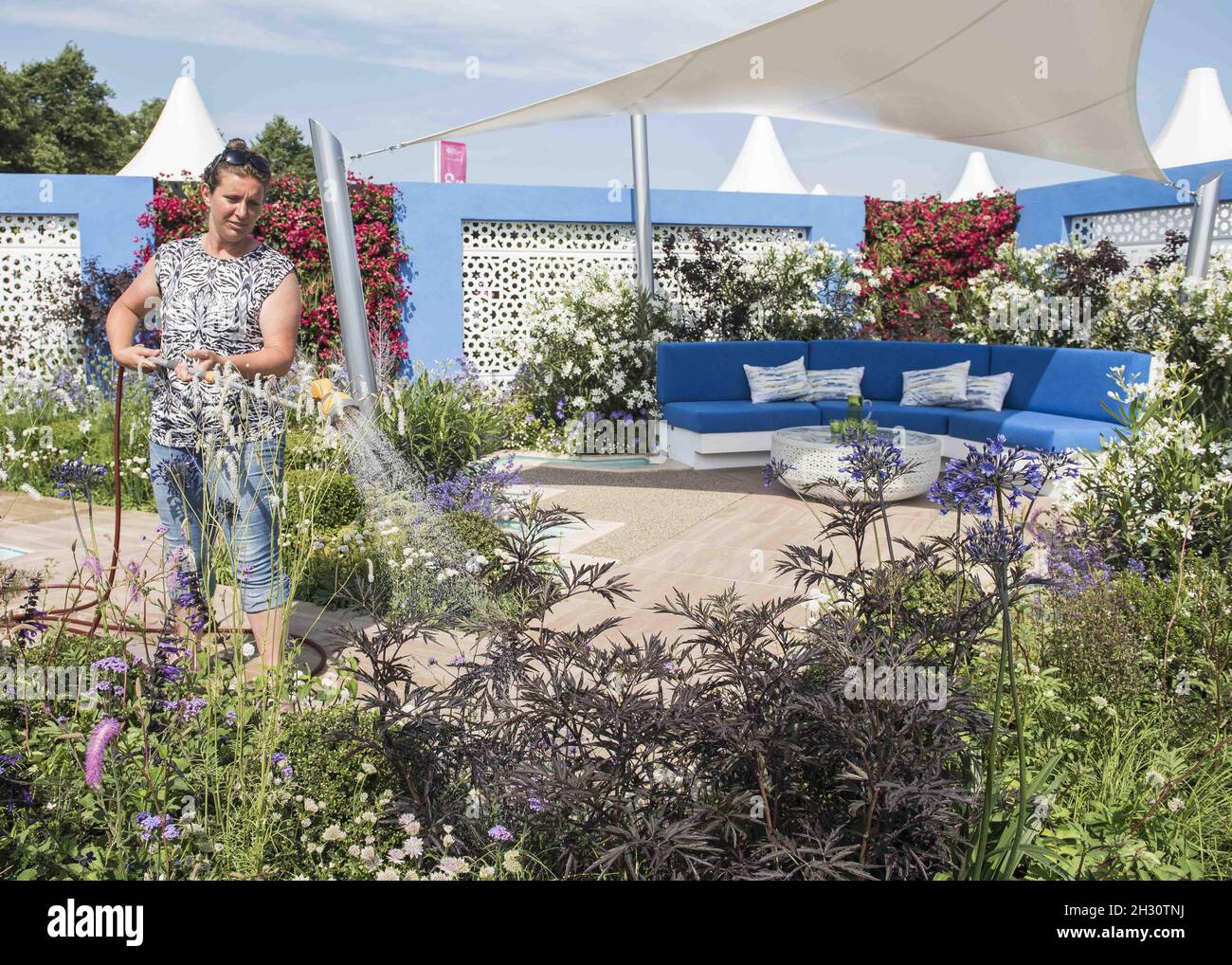 A gardener waters the Noble Caledonia 'Spirit of the Aegean' garden as ...