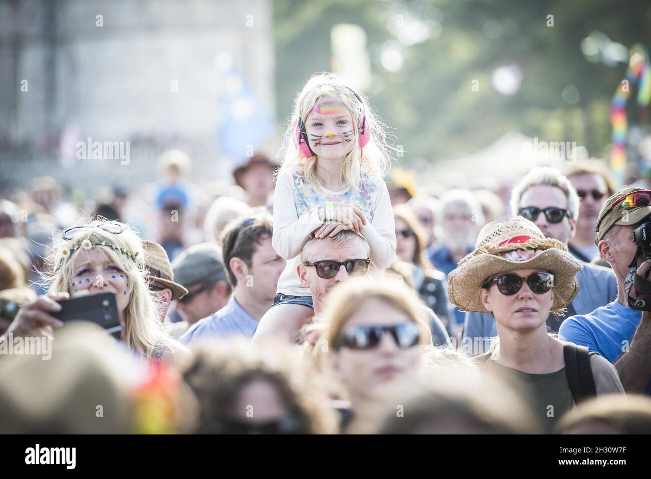 A young festival goer on her fathers shoulders in the crowd on day 2 of ...