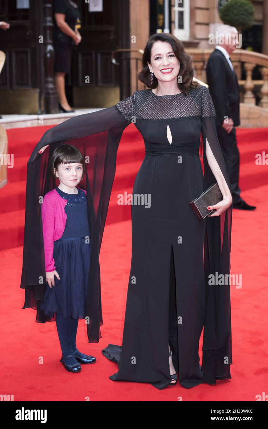 Raquel Cassidy shields Fifi Hart from the rain whilst arriving at the ...
