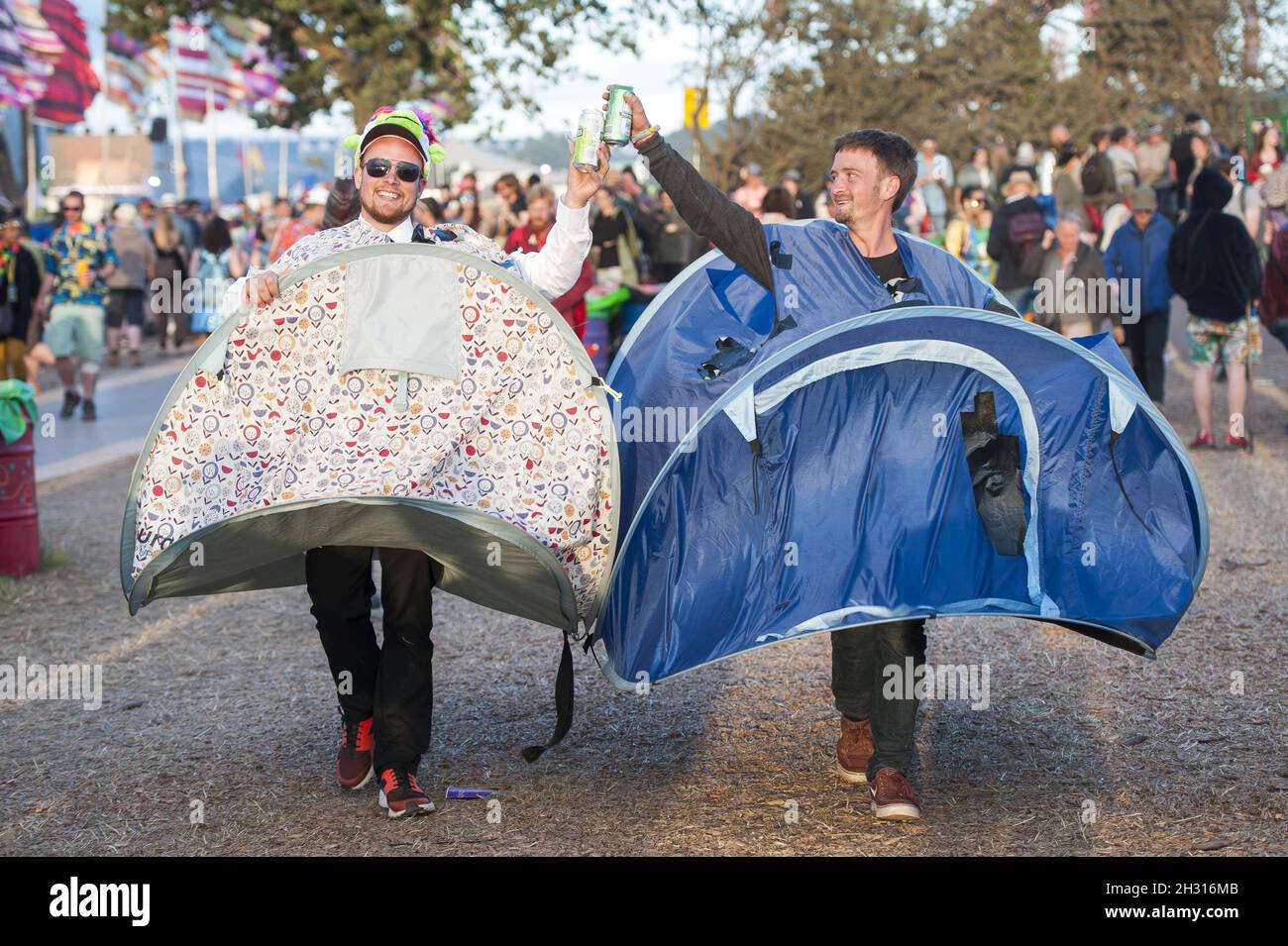 Festival Goers Wearing Tents At Glastonbury Festival At Worthy Farm
