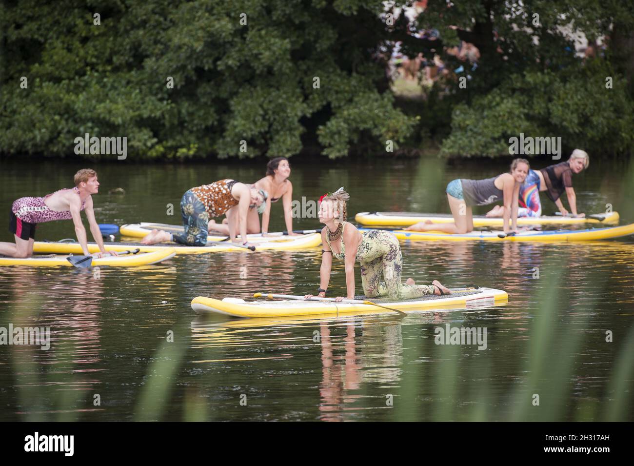 Festival goers take part in a paddle board yoga class at Shambala 2017 ...
