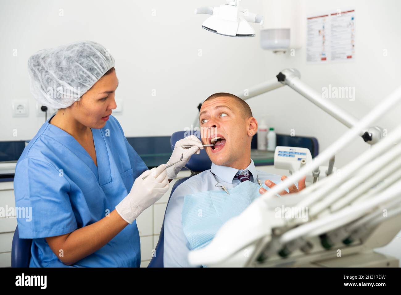 Man complains to the doctor about toothache at dentist appointment ...