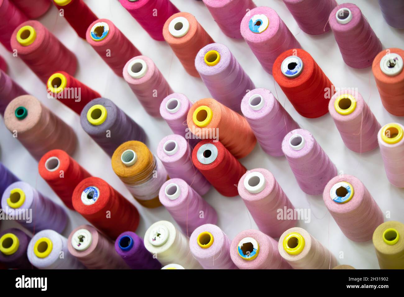 Spools of thread in various colors for the sewing studio Stock Photo ...