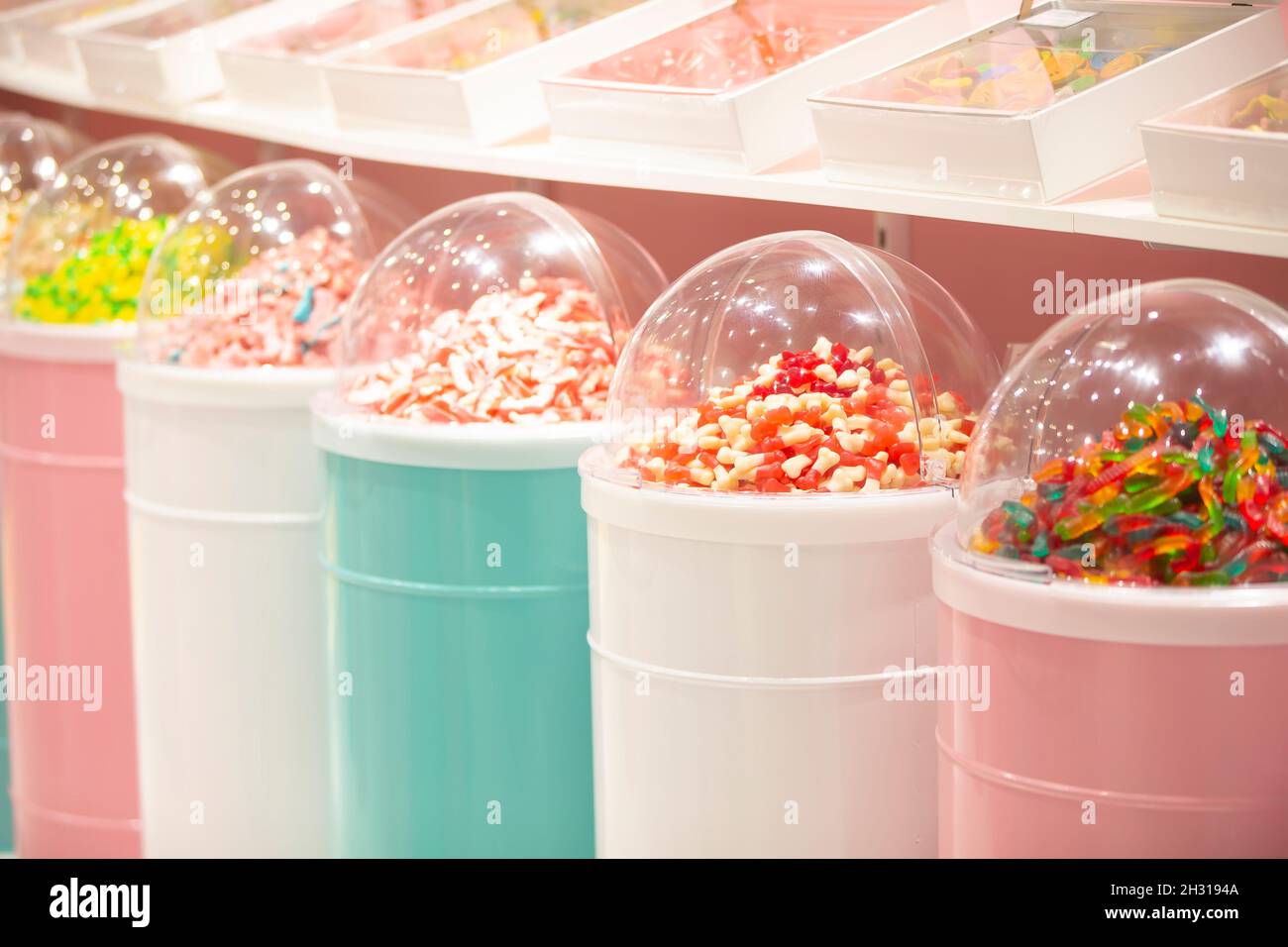 Jelly candies in containers in a store. Large selection of sweets in ...