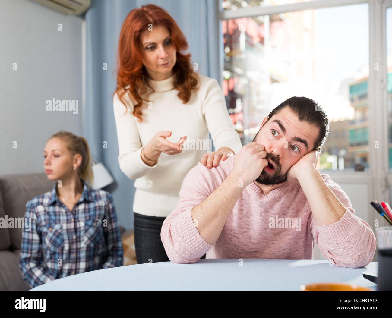 Adult guy having argue with wife and mother-in-law Stock Photo - Alamy