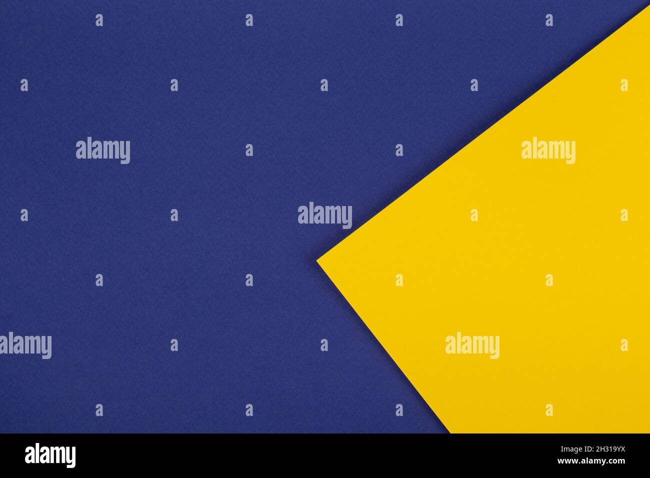 Paper blue background with yellow triangle. Colored paper geometric ...