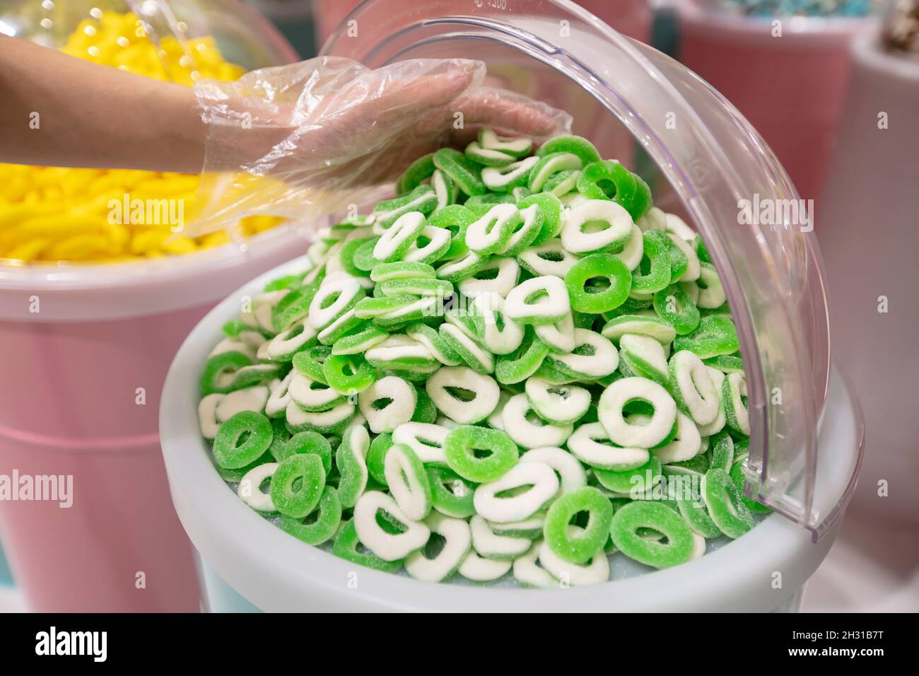 Jelly candies in containers in a store. Large selection of sweets in ...