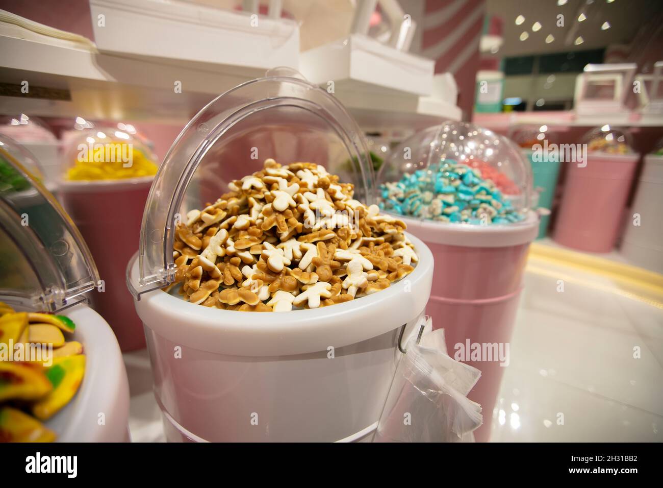 Jelly candies in containers in a store. Large selection of sweets in ...