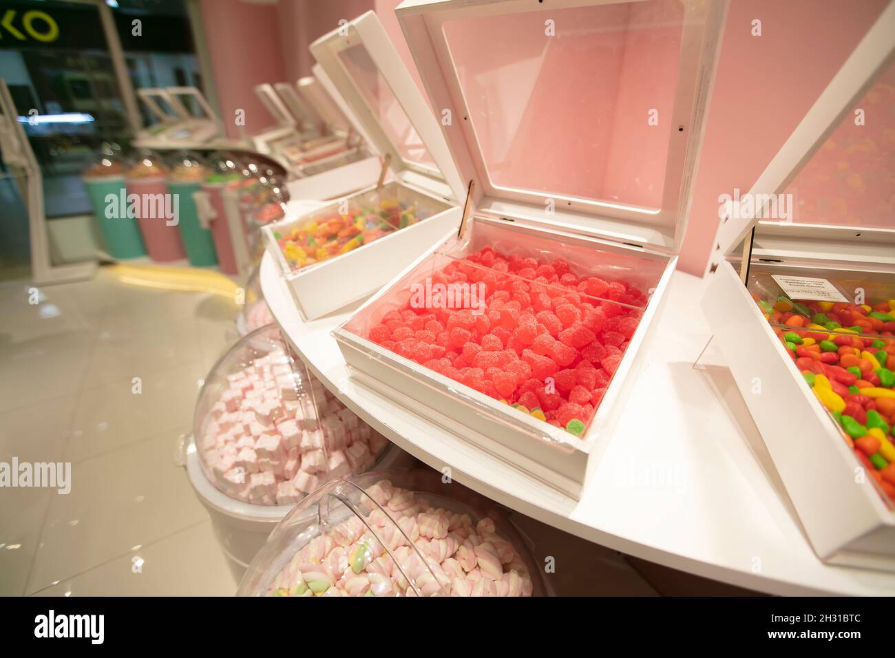 Jelly candies in containers in a store. Large selection of sweets in ...