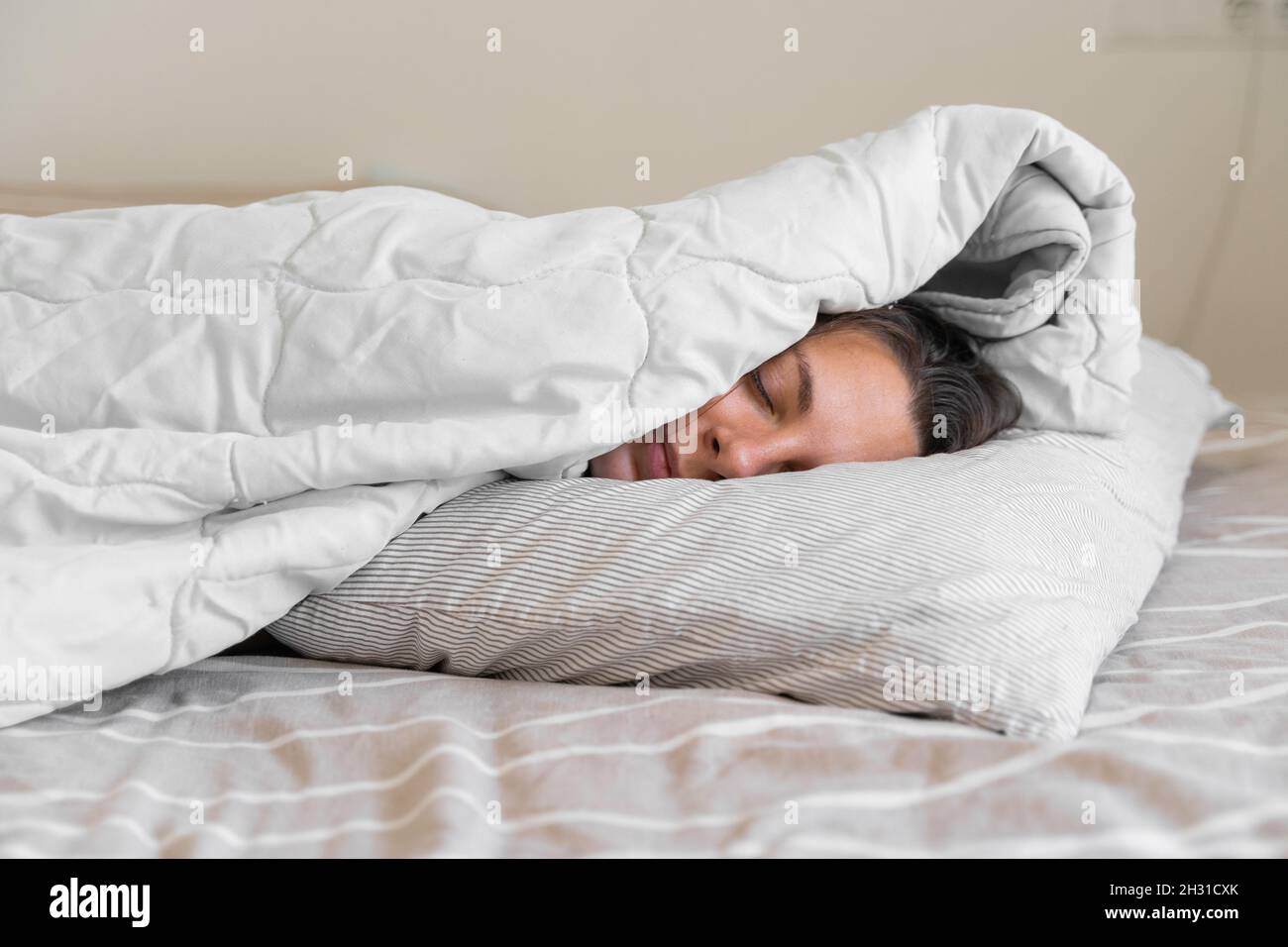 Young millennial woman sleeping covered with blanket. Cold winter. No ...
