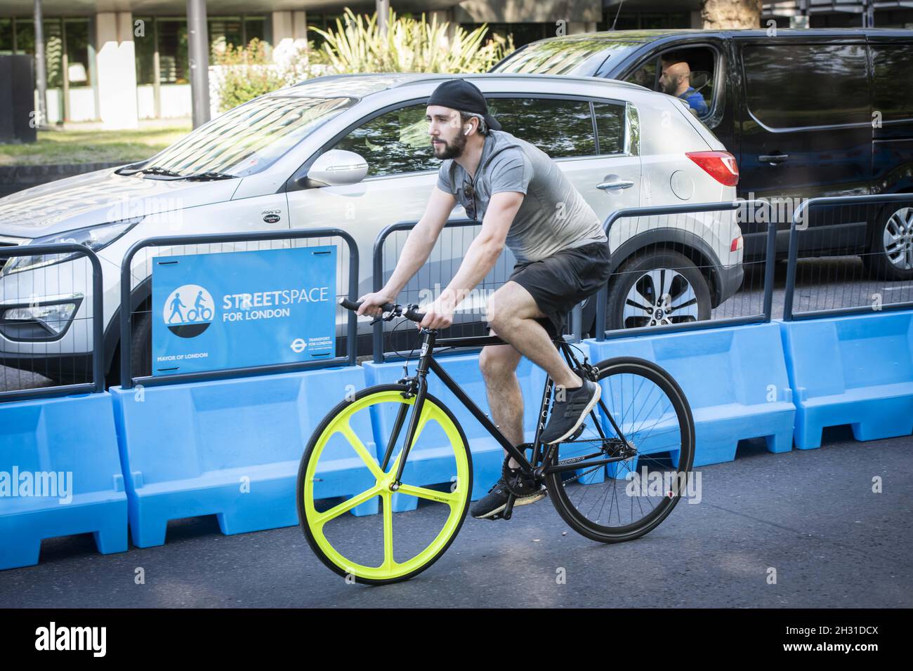 A cyclist cycles down the pop up Transport For London Streetspace cycle ...