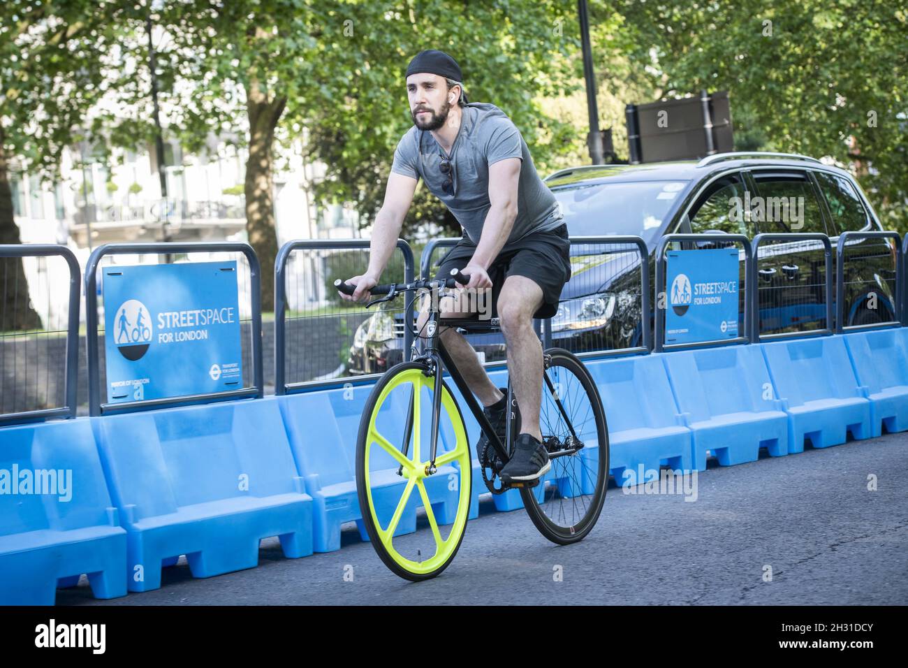 A cyclist cycles down the pop up Transport For London Streetspace cycle ...