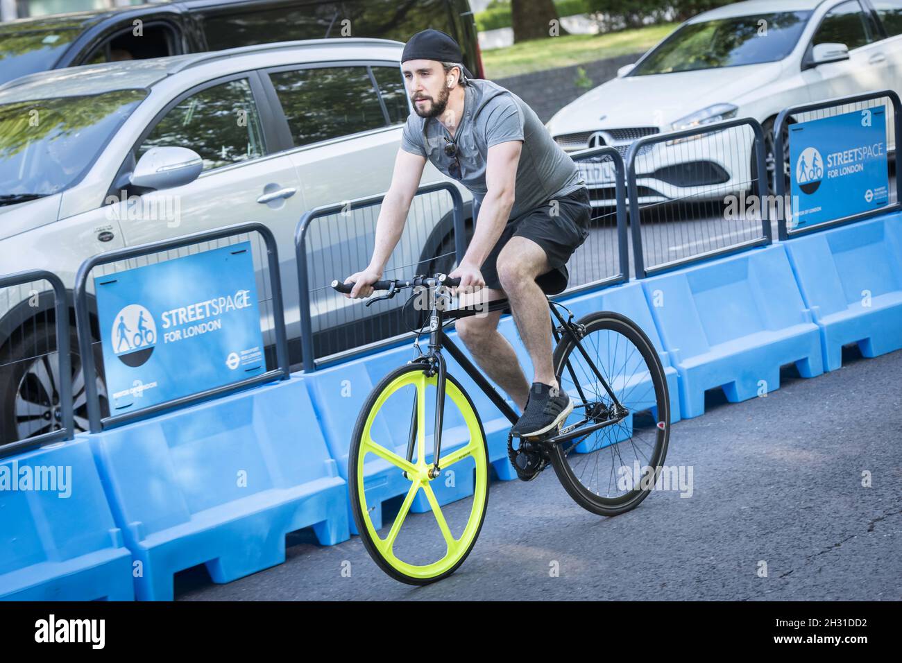 A cyclist cycles down the pop up Transport For London Streetspace cycle ...