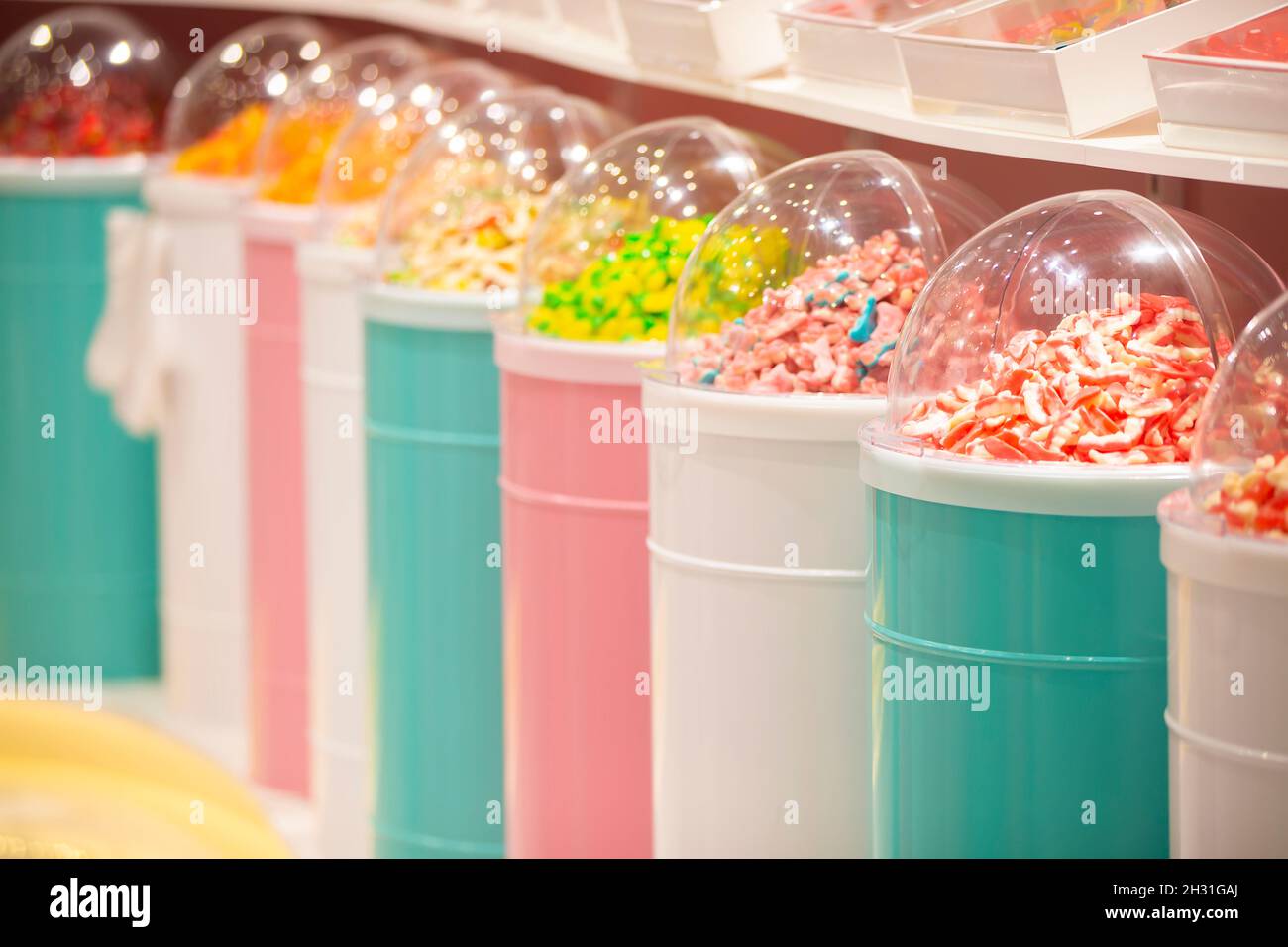 Jelly candies in containers in a store. Large selection of sweets in ...