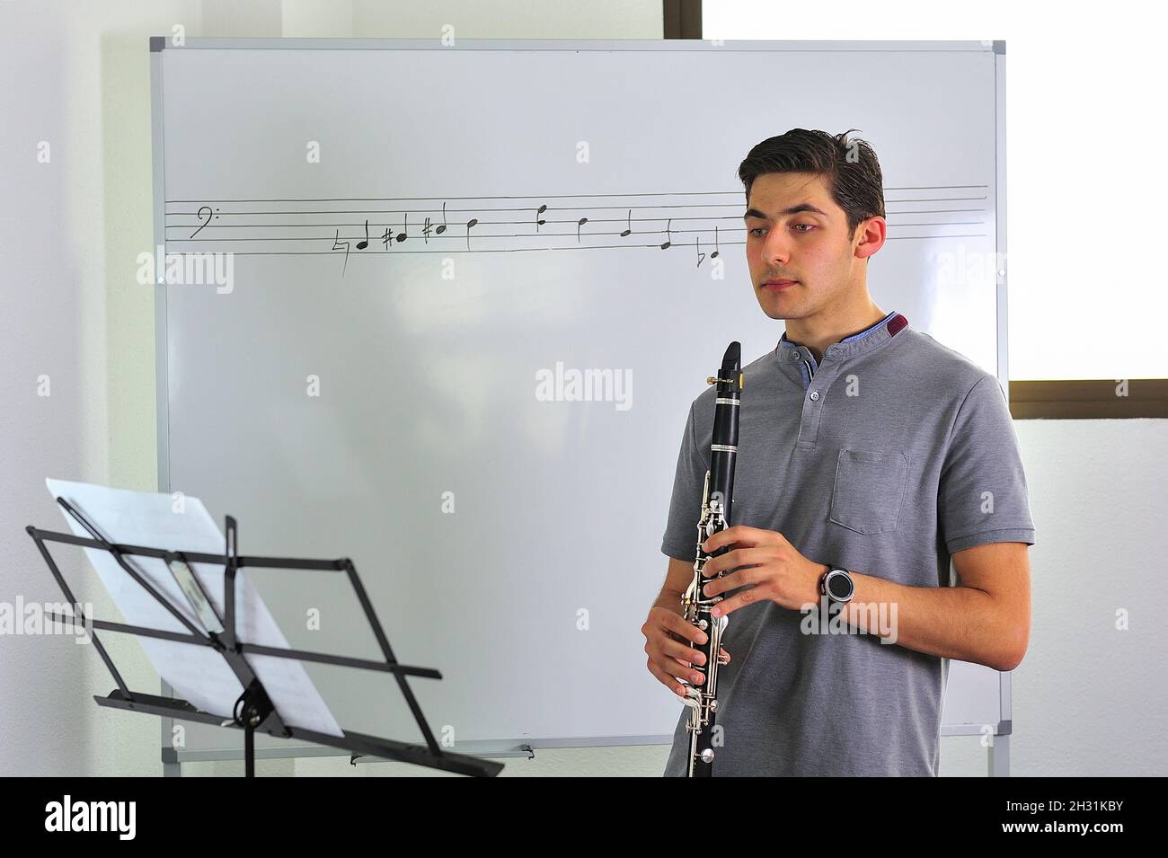 Young student studies lesson on sheet music in the classroom Stock ...