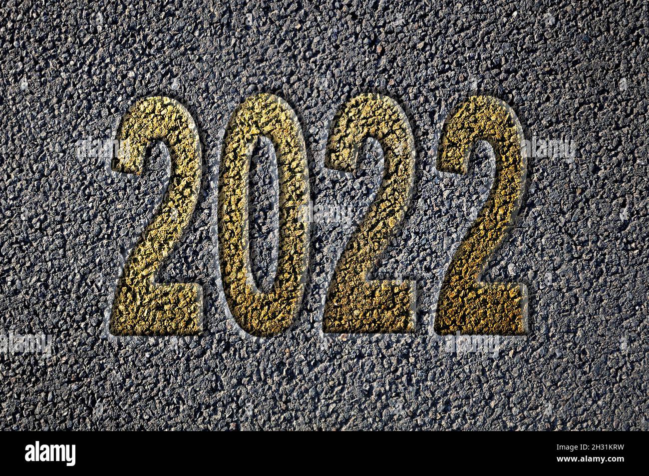 golden textured year 2022 graved on dark asphalt Stock Photo - Alamy