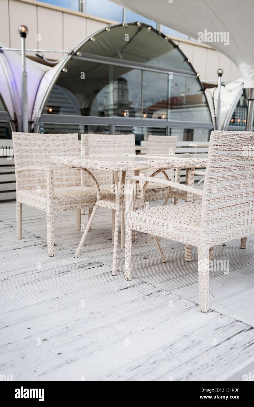 cozy outdoor cafe with light chairs Stock Photo - Alamy