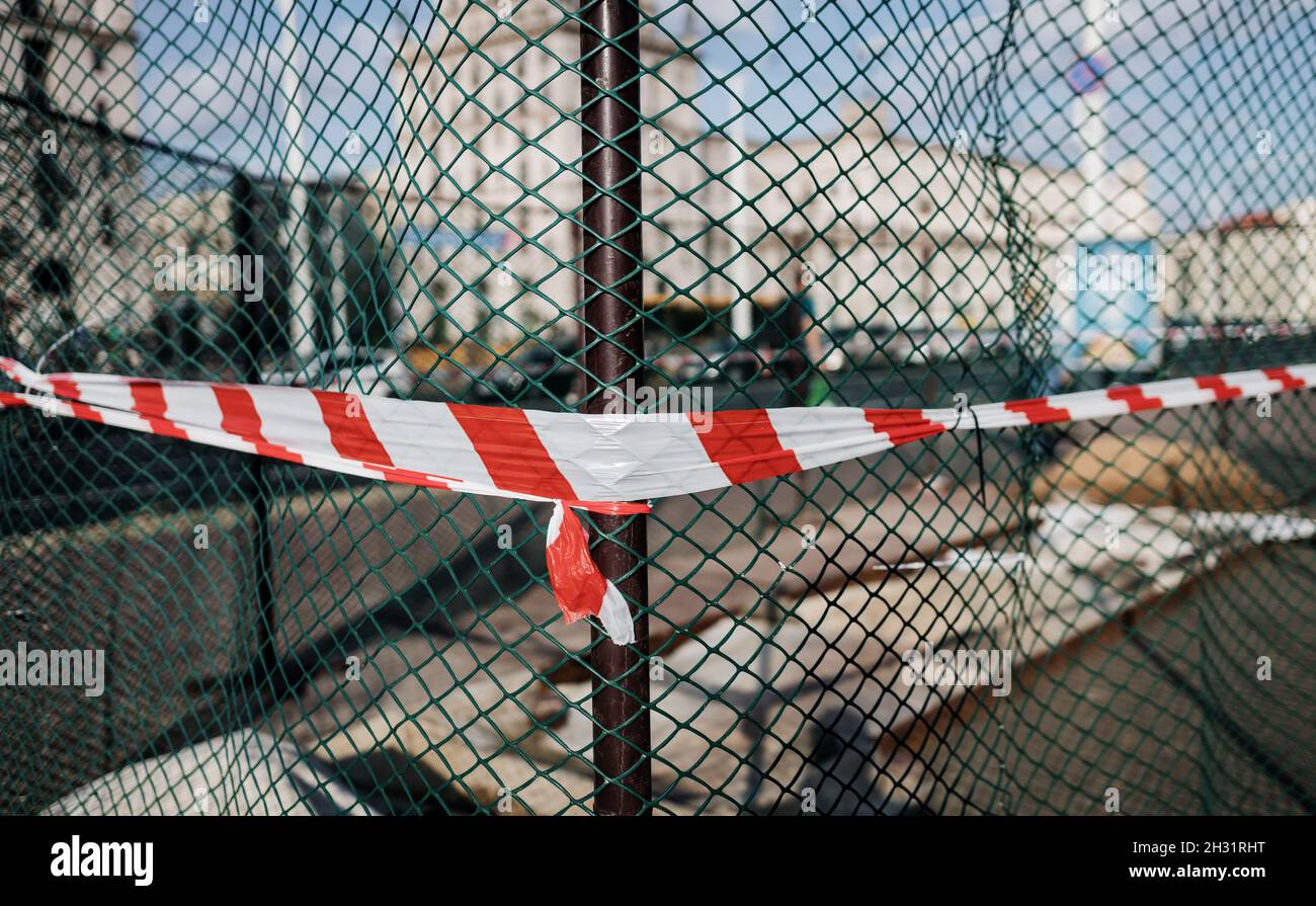 Signal protective tape on grid. The fence on the construction site is ...