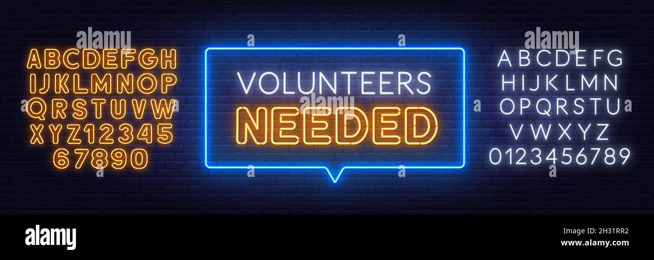 Neon sign volunteers needed in the speech bubble on brick wall ...