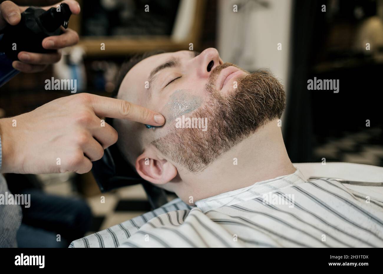 Handsome guy getting haircut hi-res stock photography and images - Alamy