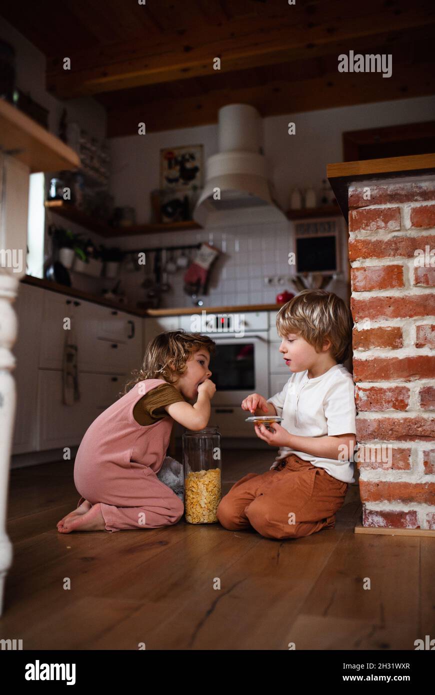 Child eating on the floor hi-res stock photography and images - Alamy